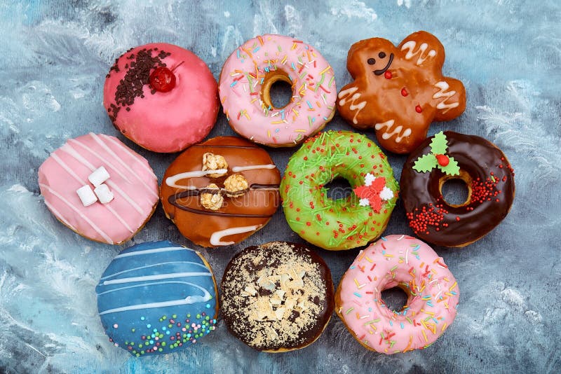 Various Colorful Donuts on Blue Background, Female Hand Takes a Donut ...