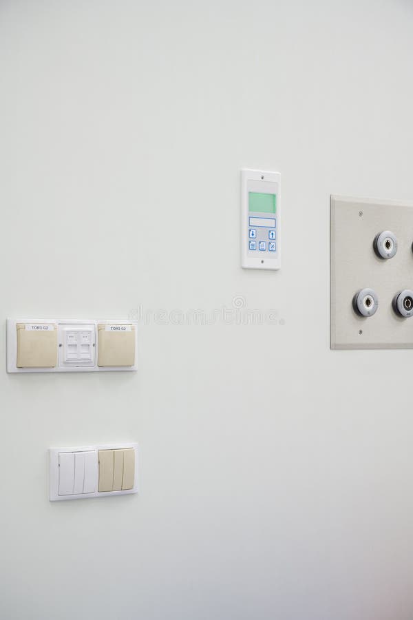 Various Control Panels and Electrical Switches on a White Wall in ...