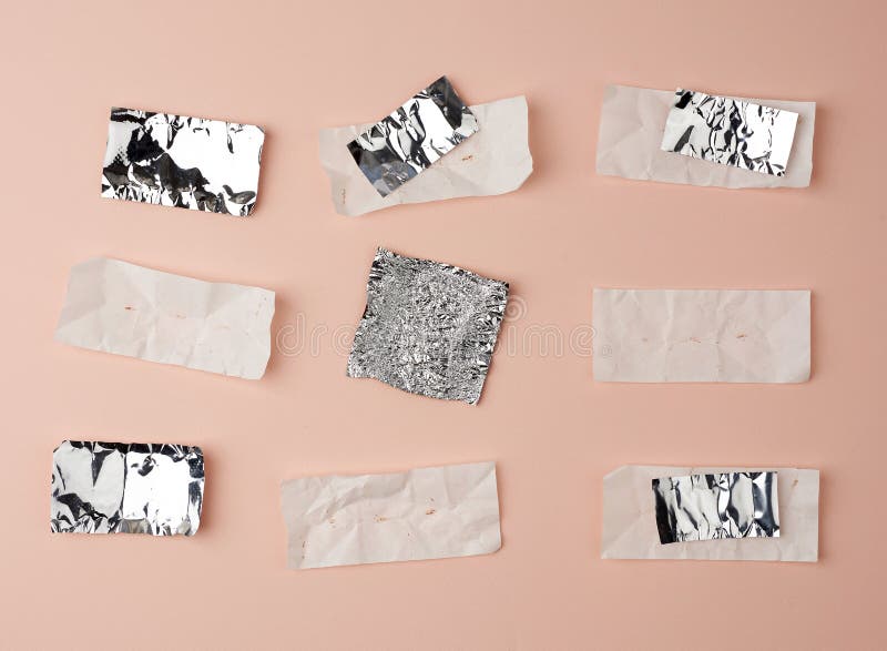 Various Crumpled Foil Used Candy Wrappers on a Beige Background Stock ...
