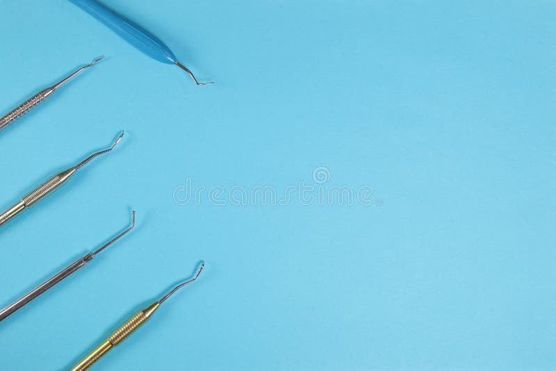 Various Dental Instruments on a Blue Background. Stock Image - Image of ...