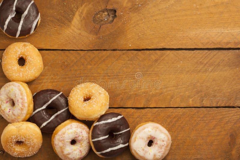 Various donuts on wood stock photo. Image of flavorful - 50484492