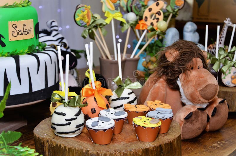 Various Egg Shaped Candy Apple and Animal Cupcakes on the Tree Trunk ...