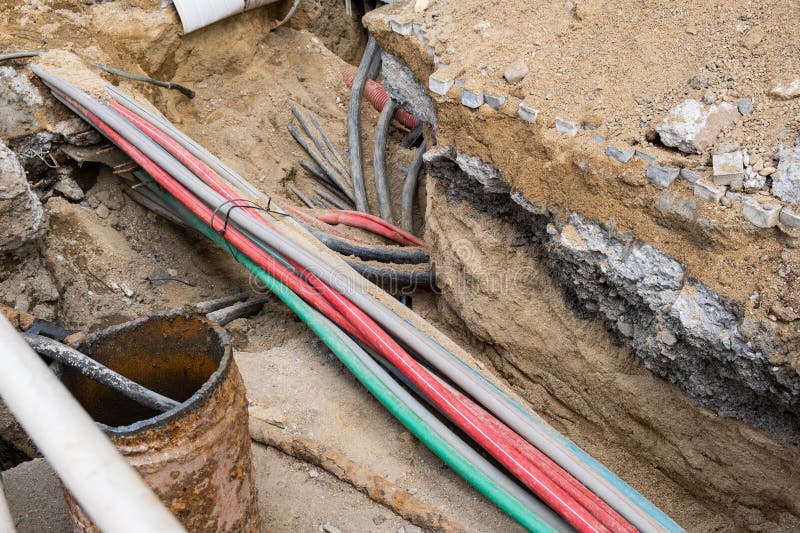Various Electrical Cables Dug Out from the Ground on the Street Laying ...