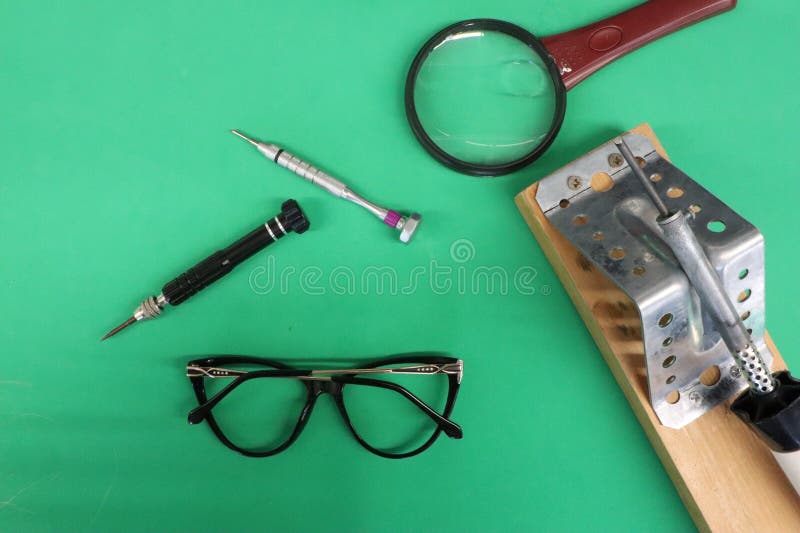 Various Electronic Components and Tools are on a Green Table Repair of ...