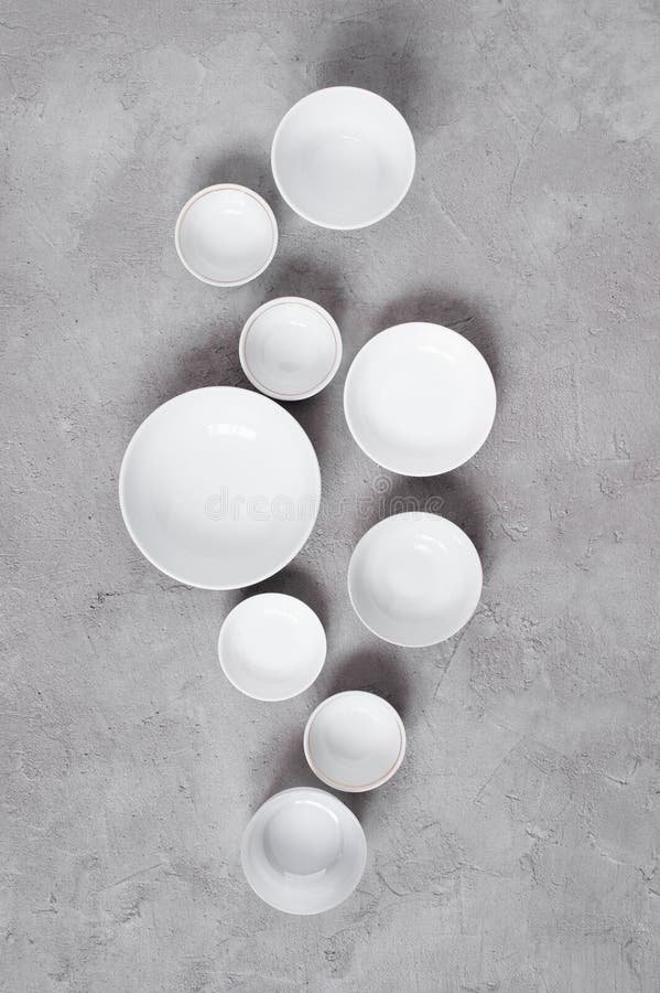 Various Empty White Plates on the Textured Grey Table Stock Image ...