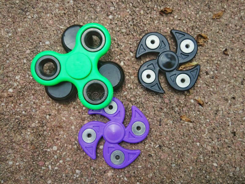 Various Fidget Spinner Over the Sand Stock Photo - Image of color ...