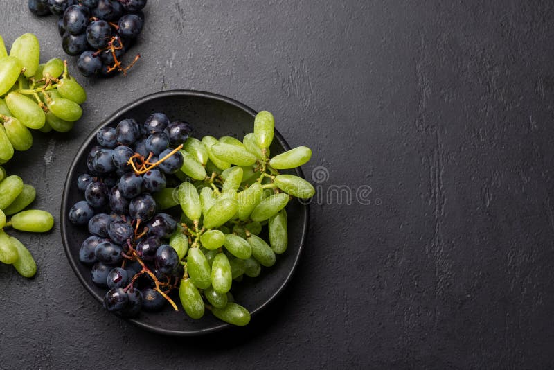 Various grapes on a table stock photo. Image of collection - 288828086