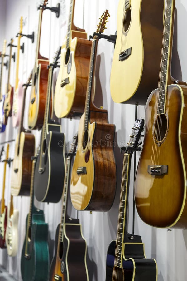 Various Guitars of Different Models Hang in the Store for Sale Stock ...