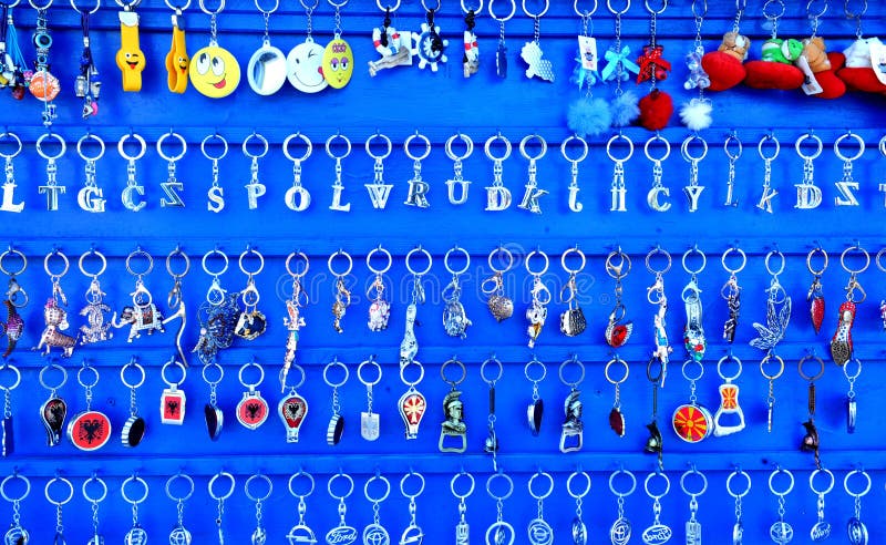 Various Key Chains for Sale on a Blue Background Stock Image - Image of ...