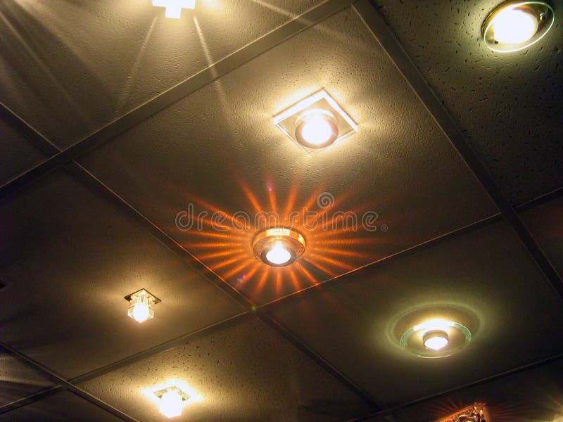 Various Lamps and Chandeliers Illuminate the Ceiling of the Apartment ...