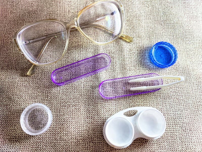 Collection of Lens Accessories on a Textured Surface with Glasses and ...