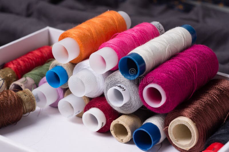 Various Multicolored Used Sewing Threads in a Box, Stacked in a Stock ...