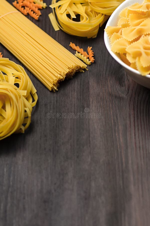 Various Pasta Types on Wooden Background. Raw Pasta Assortment, Top ...