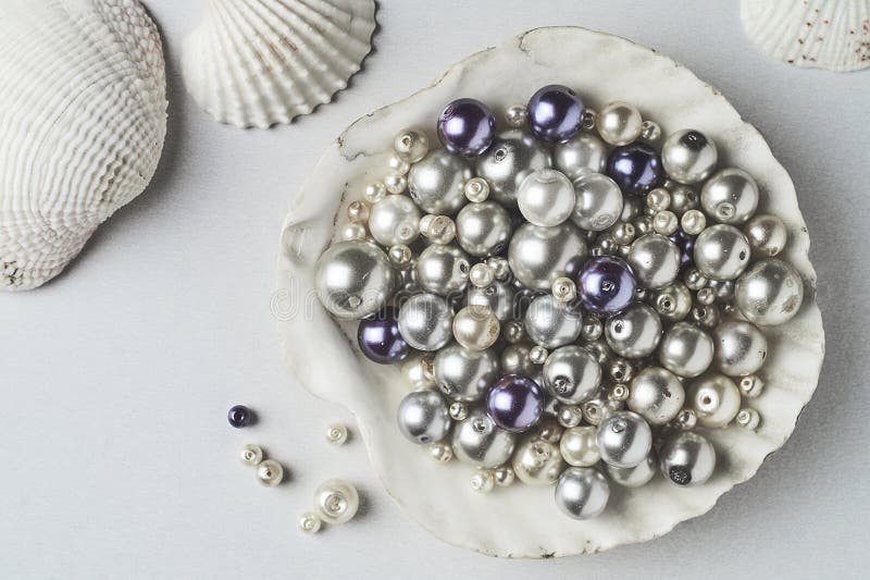 Various Pearl Beads in a Large Shell Stock Photo - Image of yellow ...