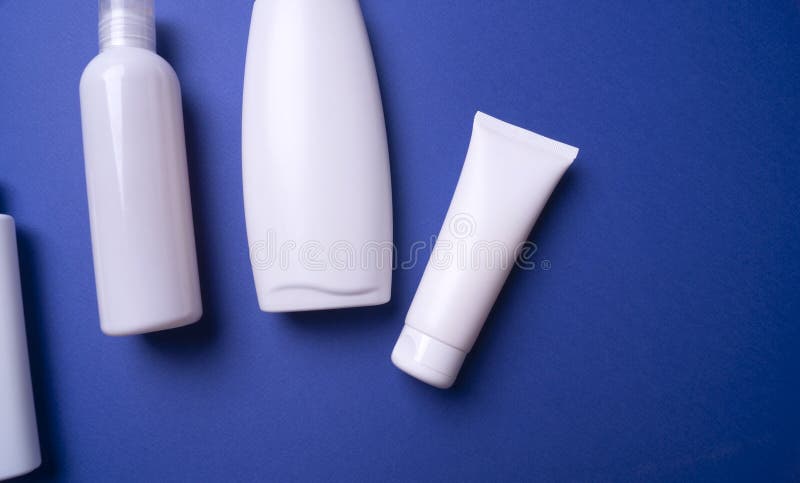Various Plastic Packaging for Shampoo and Cream on a Blue Background ...