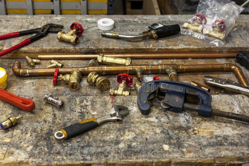 Various Plumbing Tools and Fittings on a Workbench Stock Image - Image ...