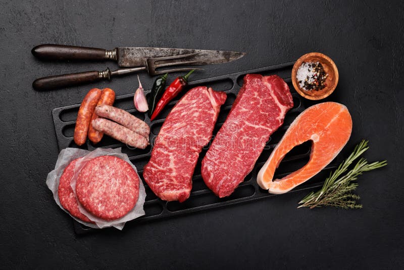 Various Raw Meat and Fish. Steaks, Sausages, Salmon and Spices Stock ...