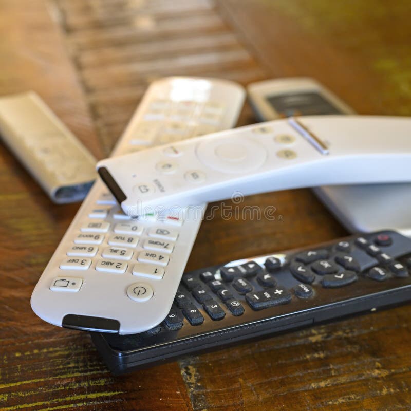 Various Remote Controls Lying on a Wooden Table Stock Photo - Image of ...