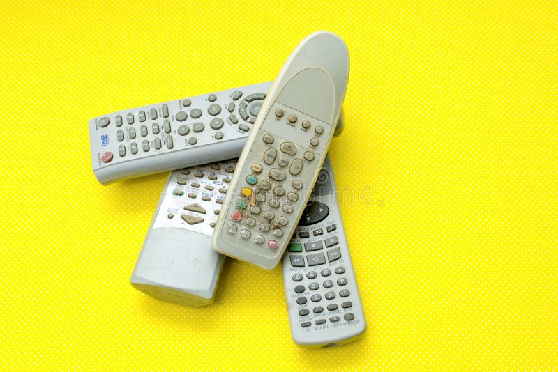 Various Remote Controls on Yellow Background Stock Photo - Image of ...