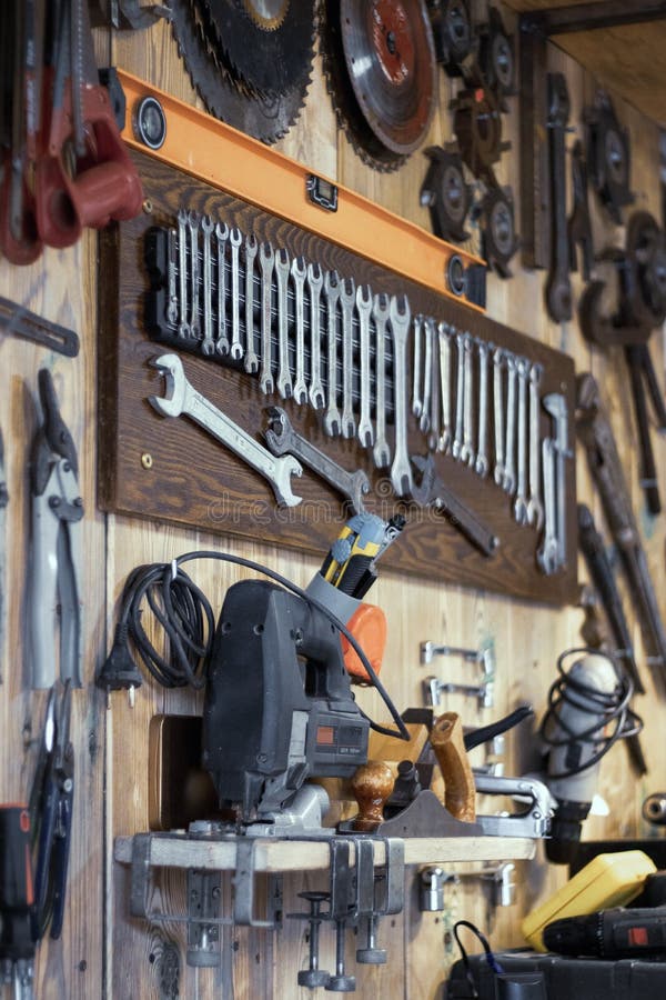 Various Tools Hang on a Wooden Wall in a Workshop Stock Image - Image ...
