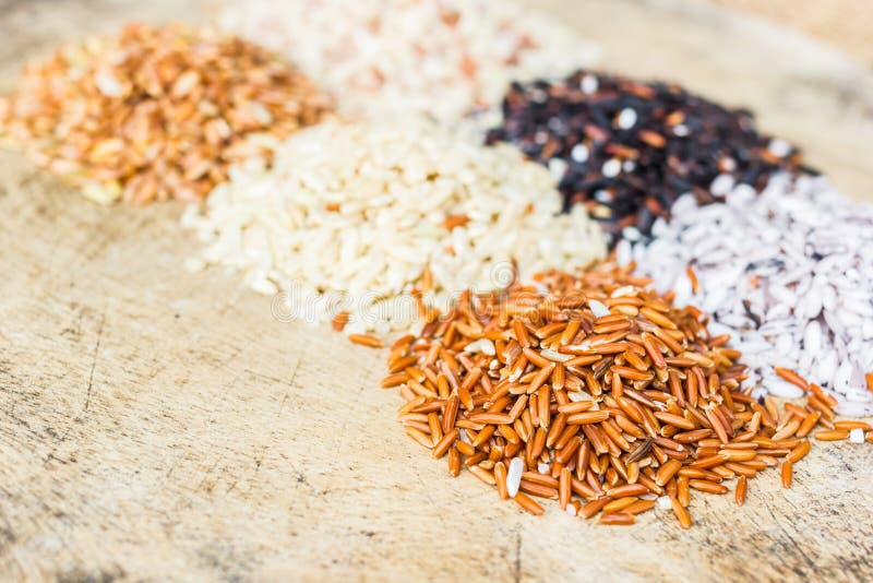 Various Rice Types Each within an Individual Pile on Rustic Wood Stock ...