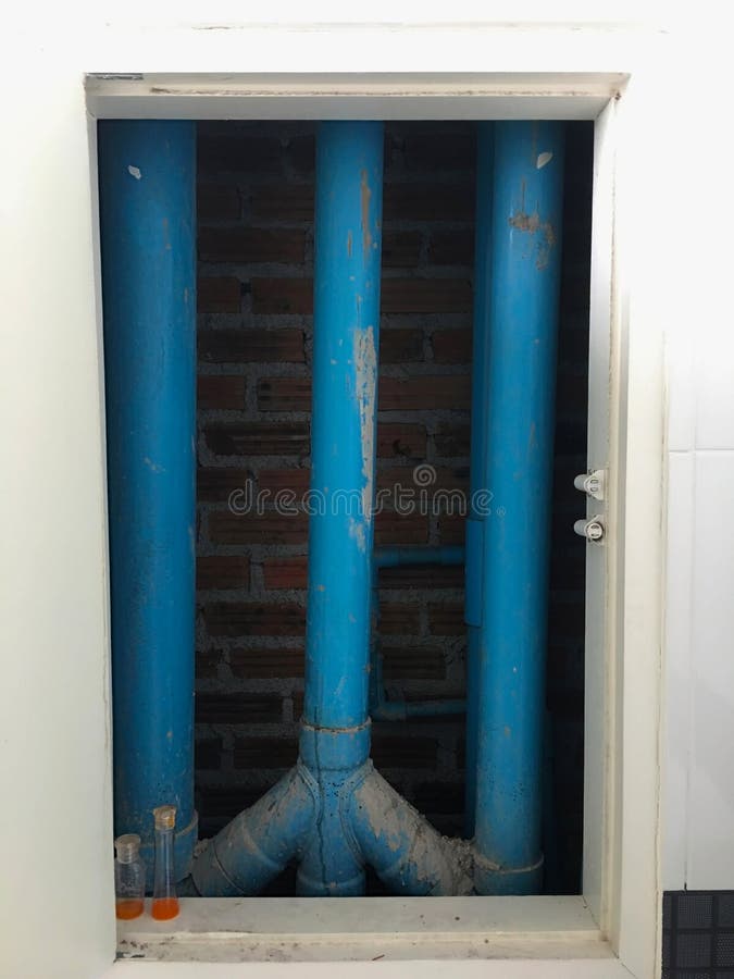 Various Sizes of Blue PVC Water Pipes are Hidden Behind the Brick Wall ...