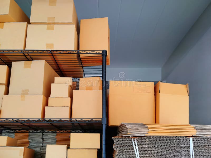 Various Sizes of Carton Boxes on Shelf Display with Stack of Folding ...
