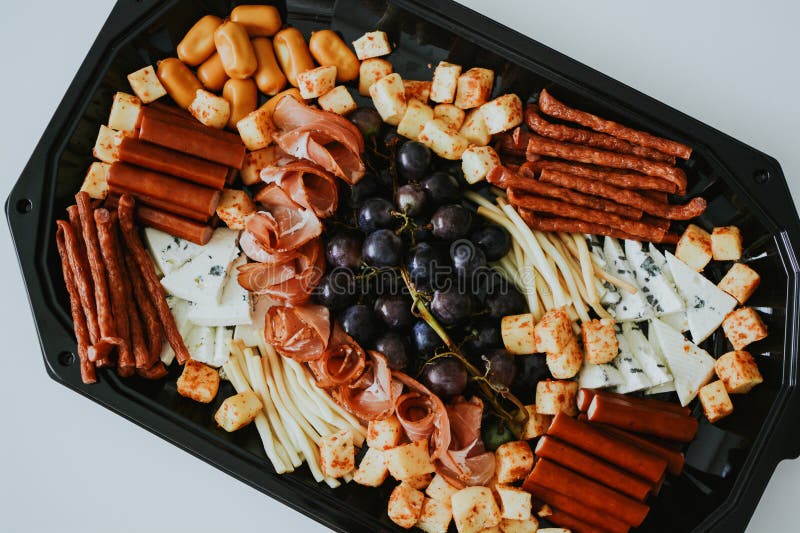 Various Snacks in the Form of Meats and Cheeses with Grape on a Plate ...