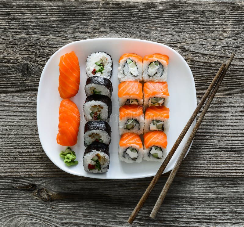 Sushi on Plate with Chopsticks Stock Photo - Image of rice, salmon ...