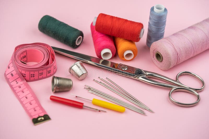 Various Tailor Accessories and Tools for Tailoring on a Pink Background ...