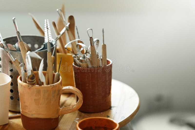 Various Tools for Carving Pottery in Mug Placed on Wooden Table in ...