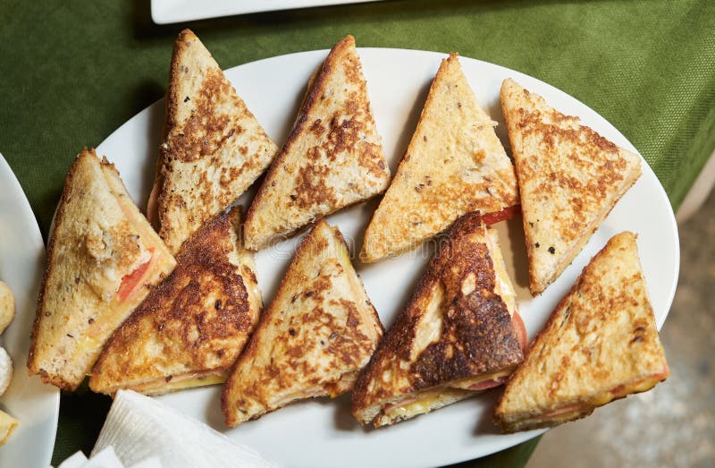 Various Triangle Toasts Sandwiches on a White Plate, Close-up Stock ...