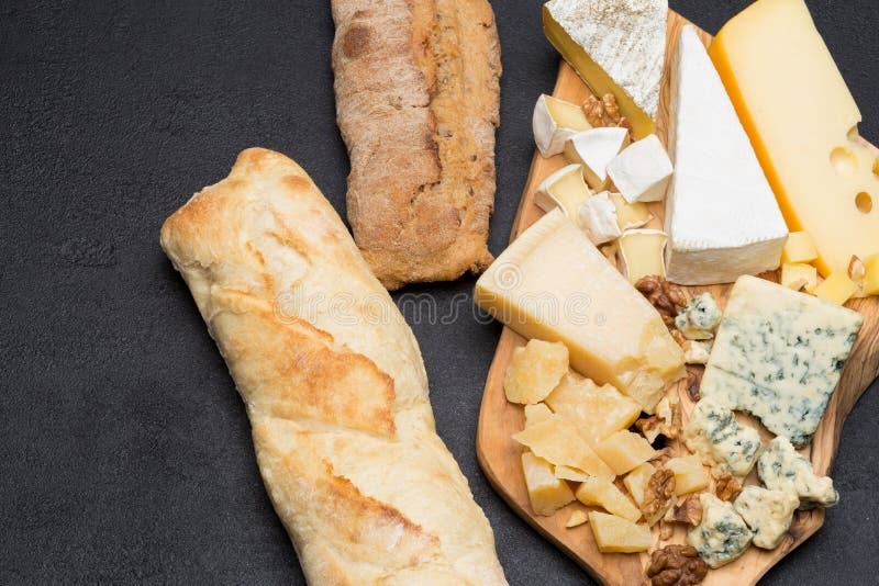 Various Types of Cheese and Bread on Wooden Board Stock Photo - Image ...