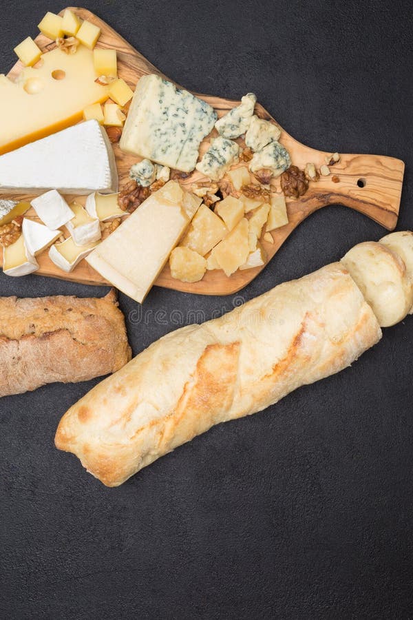 Various Types of Cheese and Bread on Wooden Board Stock Photo - Image ...