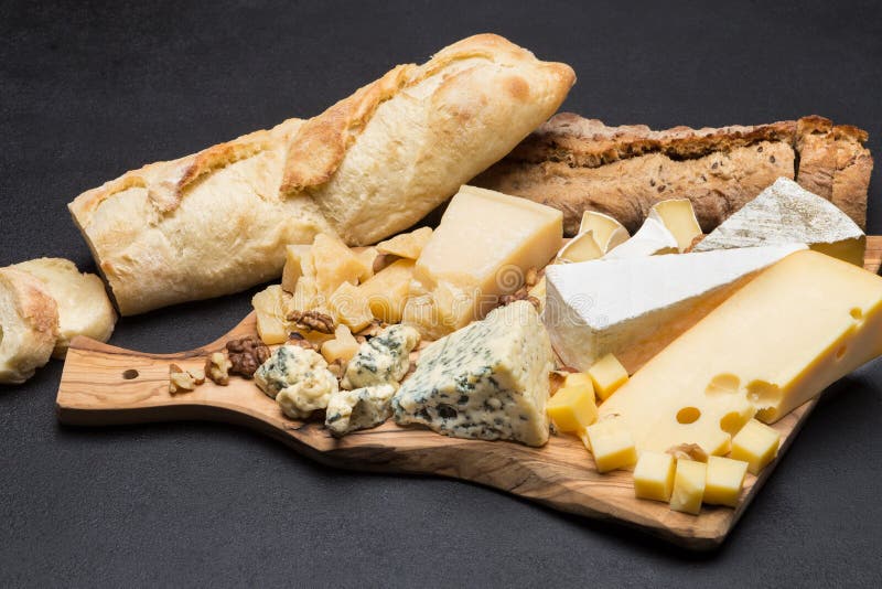 Various Types of Cheese and Bread on Wooden Board Stock Photo - Image ...