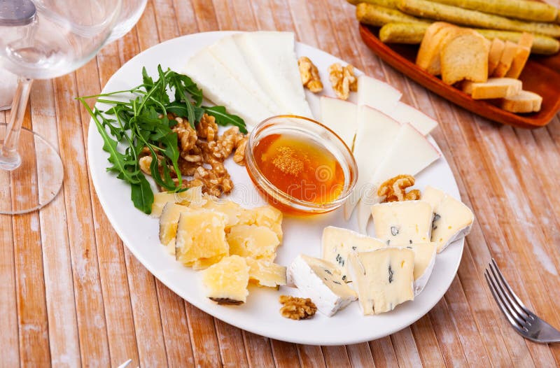 Various Types of Cheese on White Plate Stock Photo - Image of variety ...