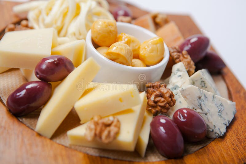 Various Types of Cheese on a Wooden Board Stock Image - Image of basil ...