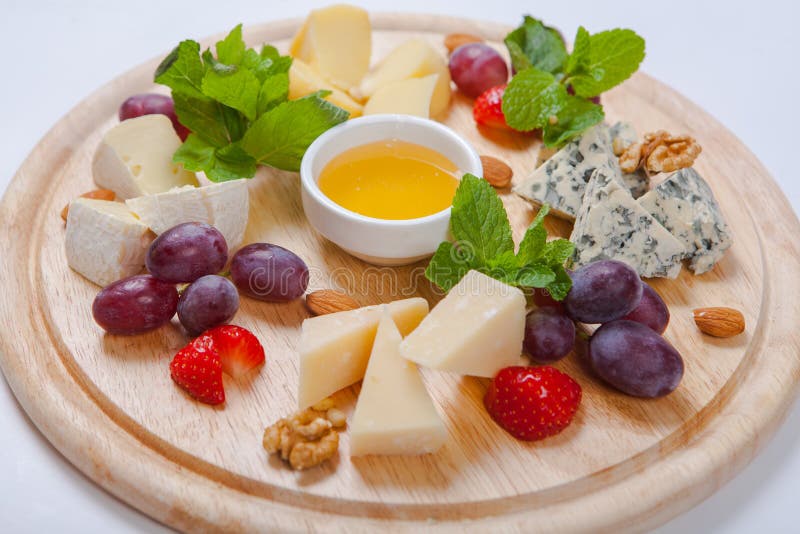 Various Types of Cheese on a Wooden Board Stock Photo - Image of ...
