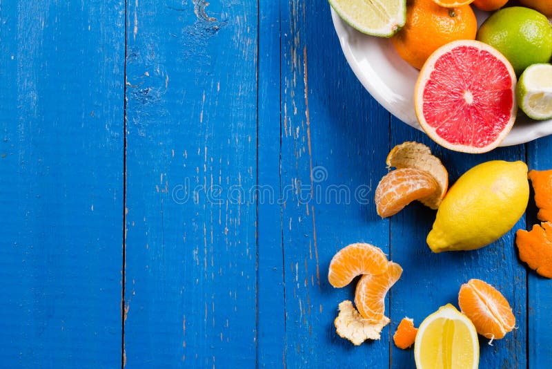 Various Types of Citrus Fruit on a Blue Painted Wooden Background Stock ...