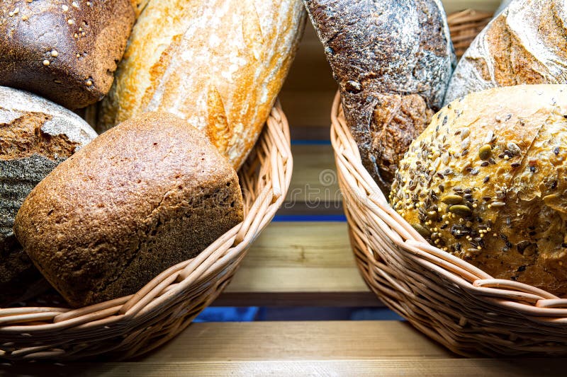 Various Types of Fresh Bread in Basket on Shelf in Bakery Stock Photo ...