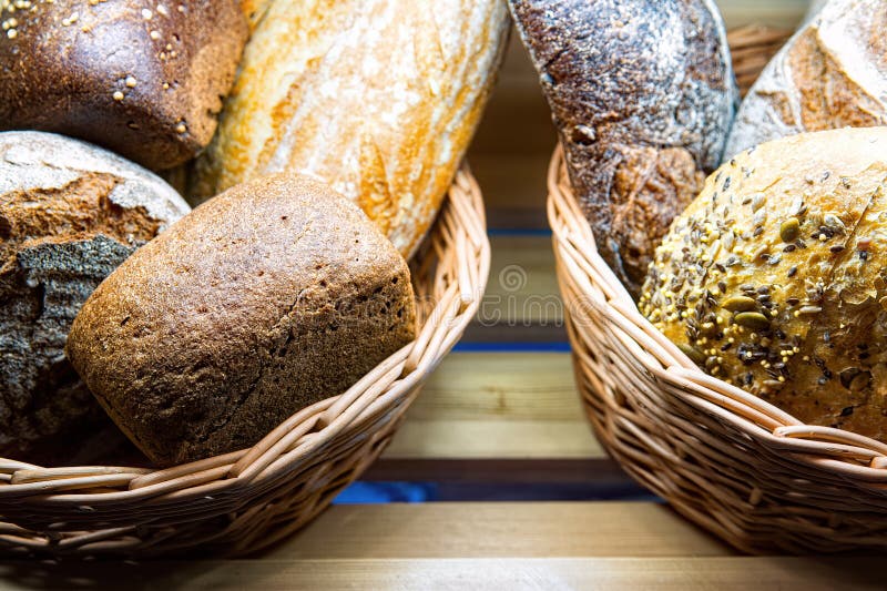 Various Types of Fresh Bread in Basket on Shelf in Bakery Stock Photo ...