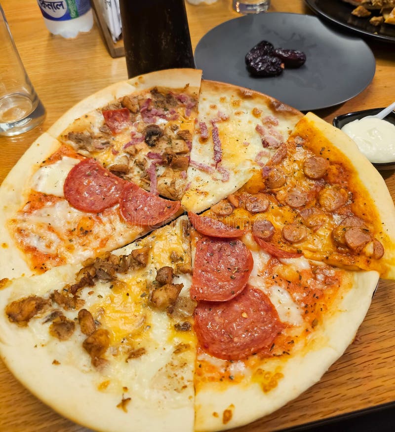 Various Types of Pizza with Different Types of Toppings Served on a ...