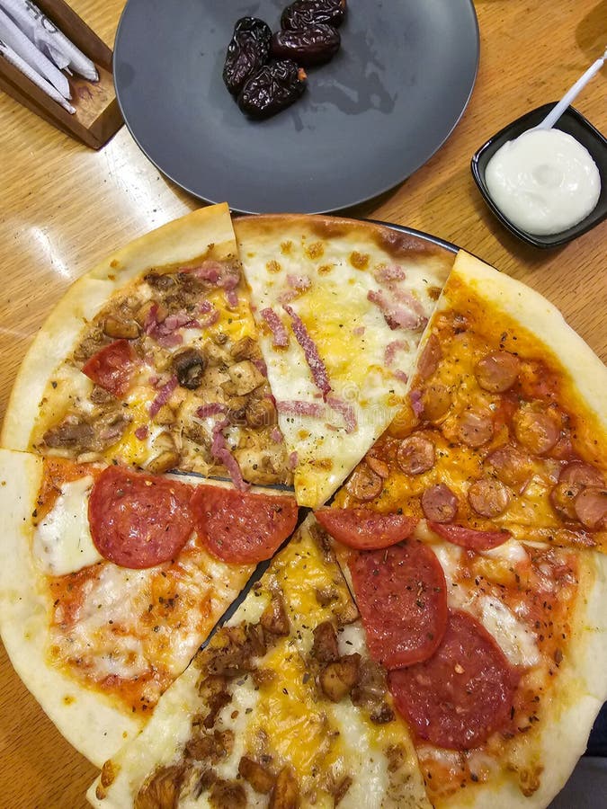 Various Types of Pizza with Different Types of Toppings Served on a ...