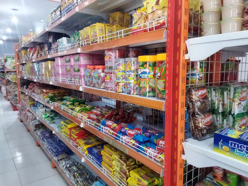 Various Types of Snacks Arranged on Minimarket Shelves. Editorial Photo ...