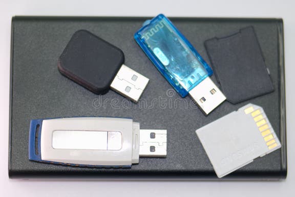 Various Types of USB Drives and Memory Cards on a Black Surface ...