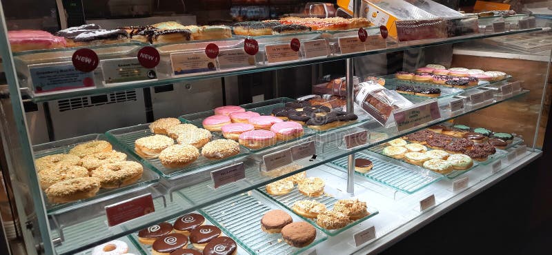 Various Variants of Donuts with Toppings in a Glass Case at the JCO ...