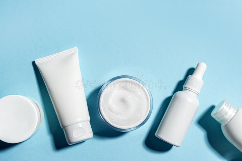 Various White Cosmetic Containers on Blue Background Stock Photo ...