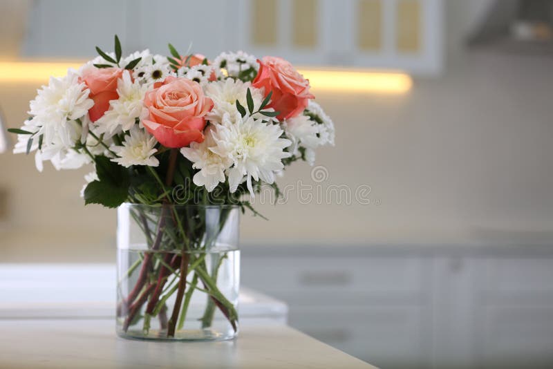 Vase with Beautiful Flowers on Countertop in Kitchen, Space for Text ...