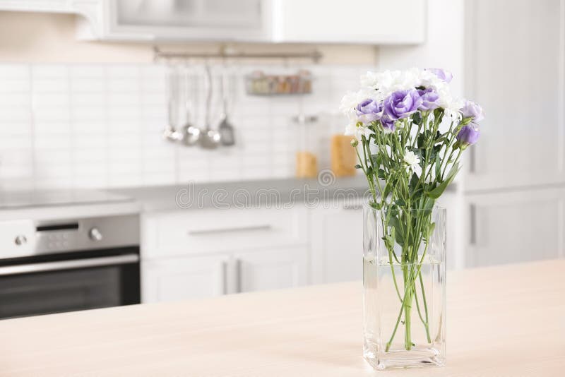 Vase with Beautiful Flowers on Table in Kitchen Interior Stock Photo ...