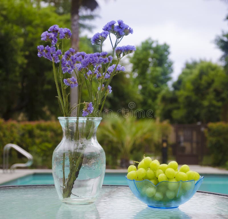 Vase with Flowers and Grapes by the Pool Stock Image - Image of flowers ...